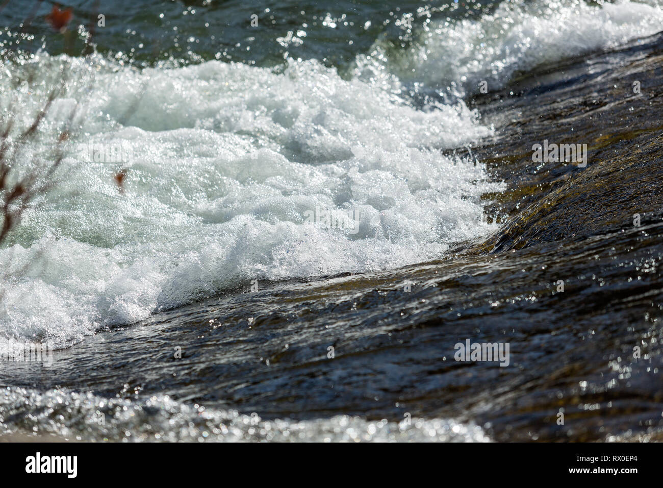 Rushing frothy water from rapids in a river Stock Photo - Alamy