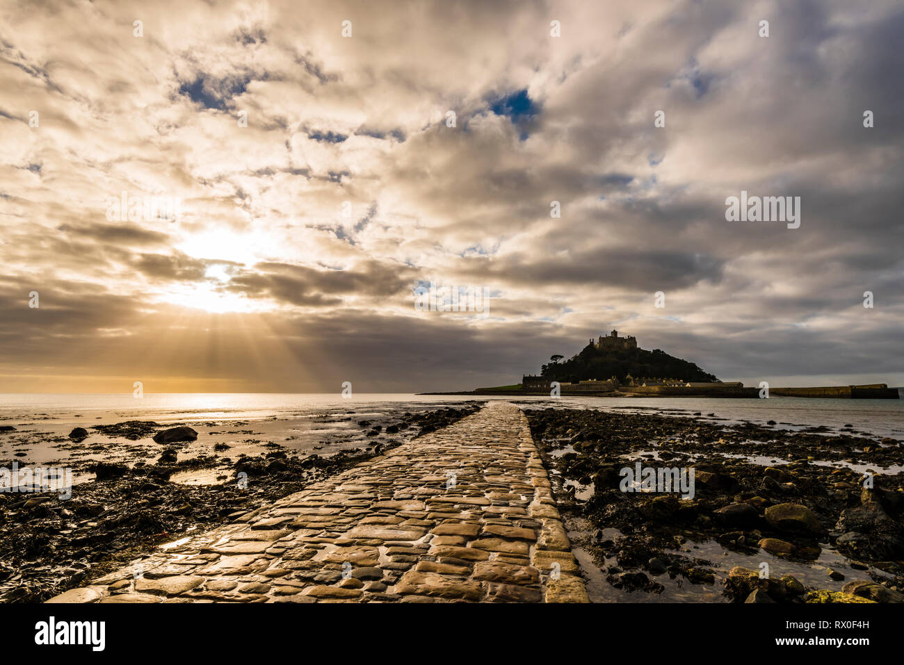 Sunburst over causeway at St Michael's Mount, Cornwall, UK Stock Photo ...