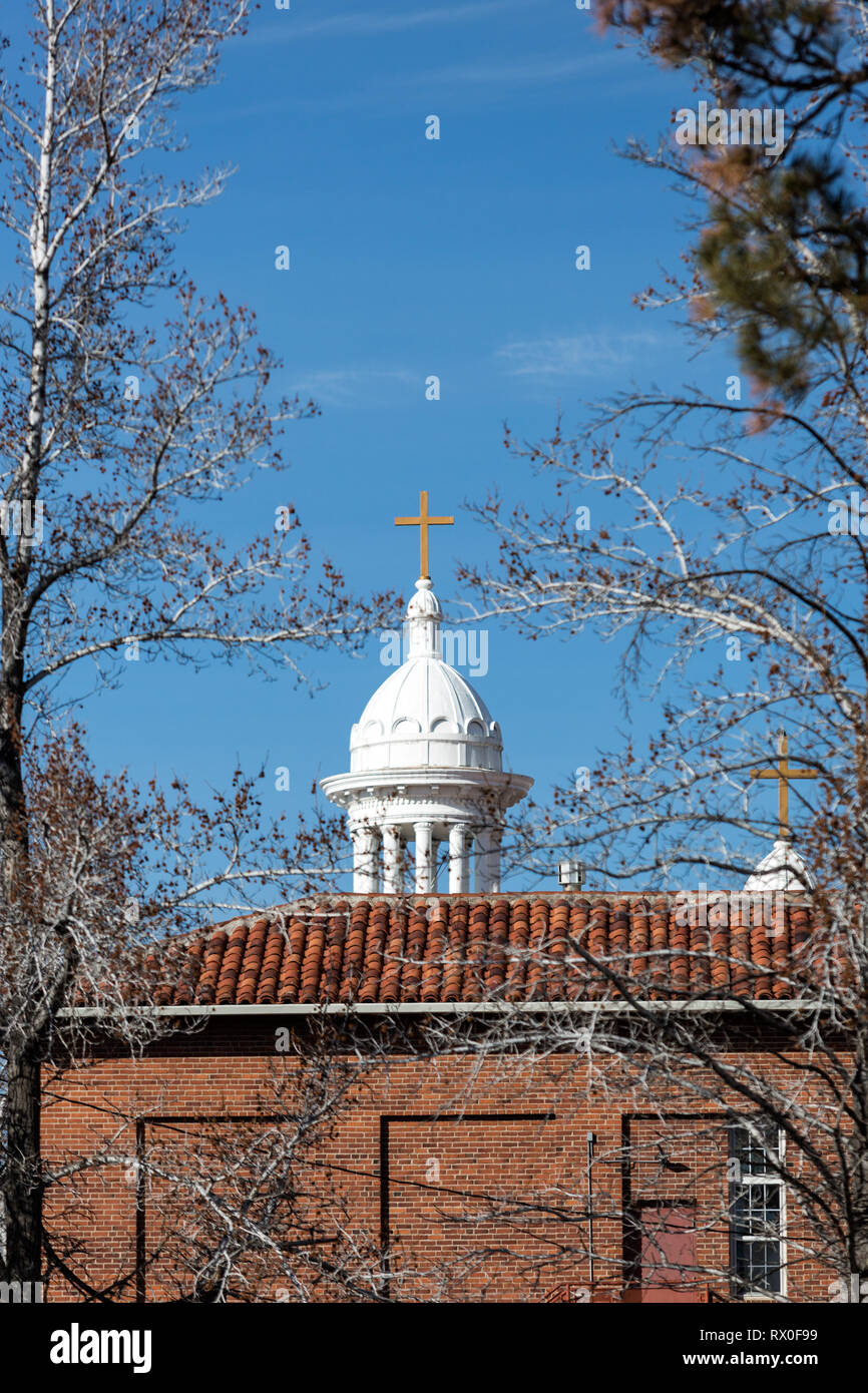 Cross on the top of a church building through the trees Stock Photo - Alamy