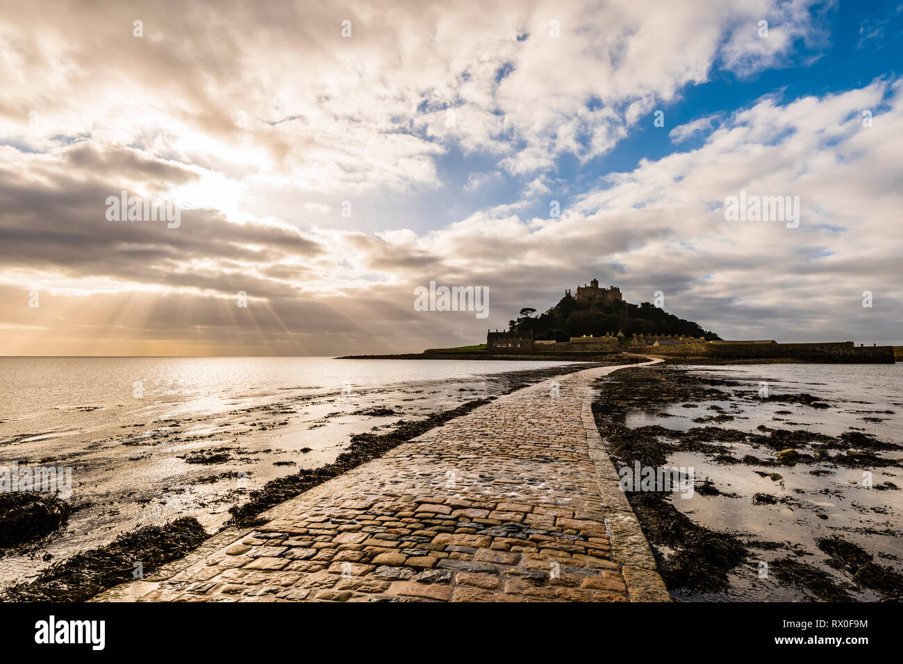 Sunburst over causeway at St Michael's Mount, Cornwall, UK Stock Photo ...
