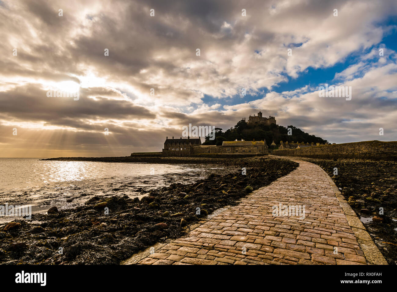 Sunburst over causeway at St Michael's Mount, Cornwall, UK Stock Photo ...