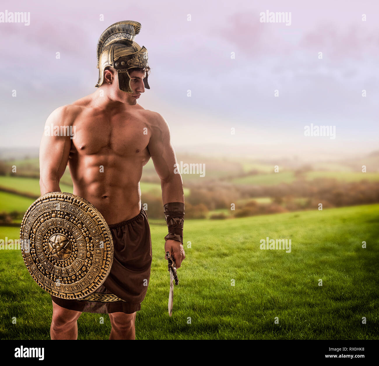 Young muscular man posing in gladiator costume Stock Photo - Alamy