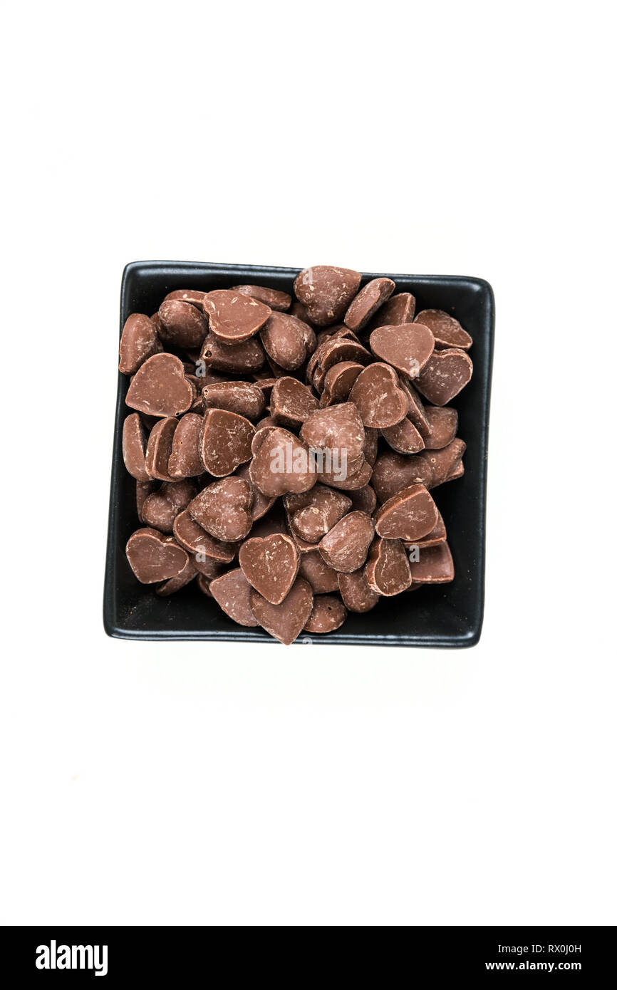 Brown candy heart shaped milk chocolate chip pieces Stock Photo - Alamy