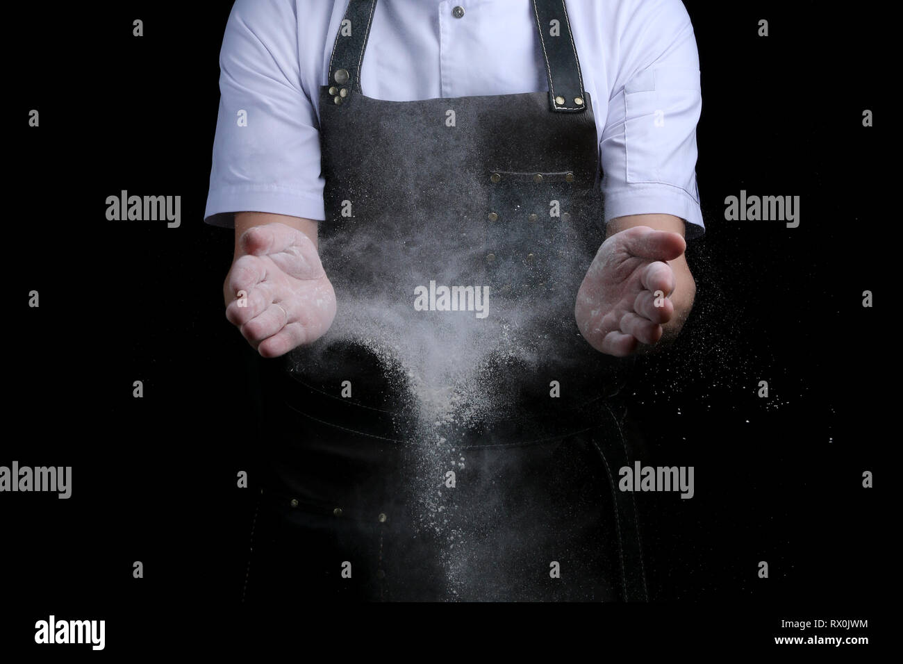 hands and flour in splash baker clap on black background Stock Photo ...