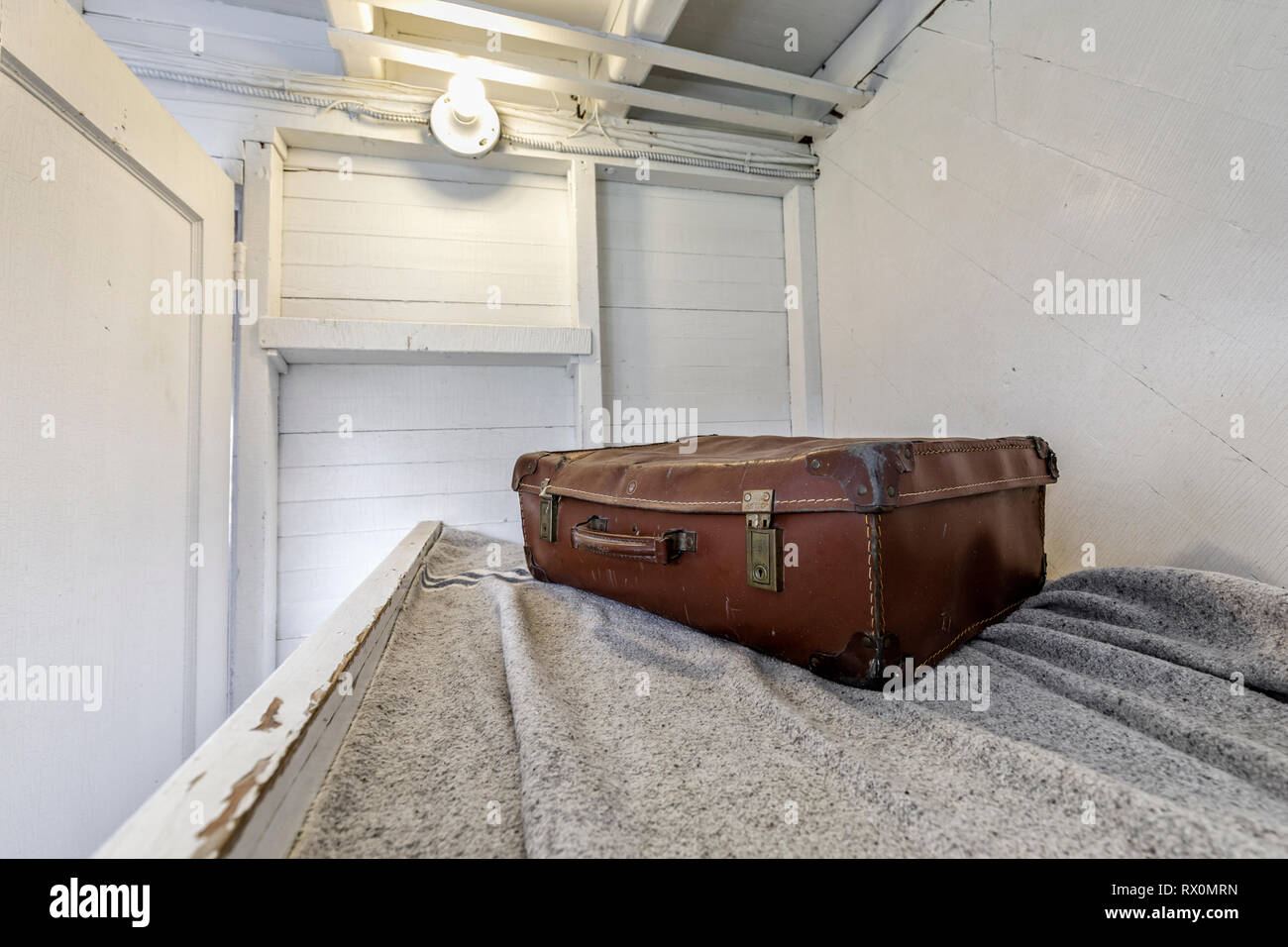 Vintage luggage on a ships passenger cabin bunk at the Marine Museum of ...
