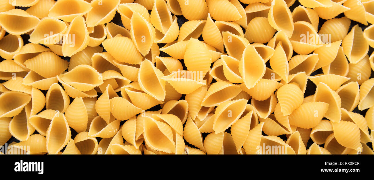 Italian food. Uncooked dry macaroni shell shape pasta texture ...