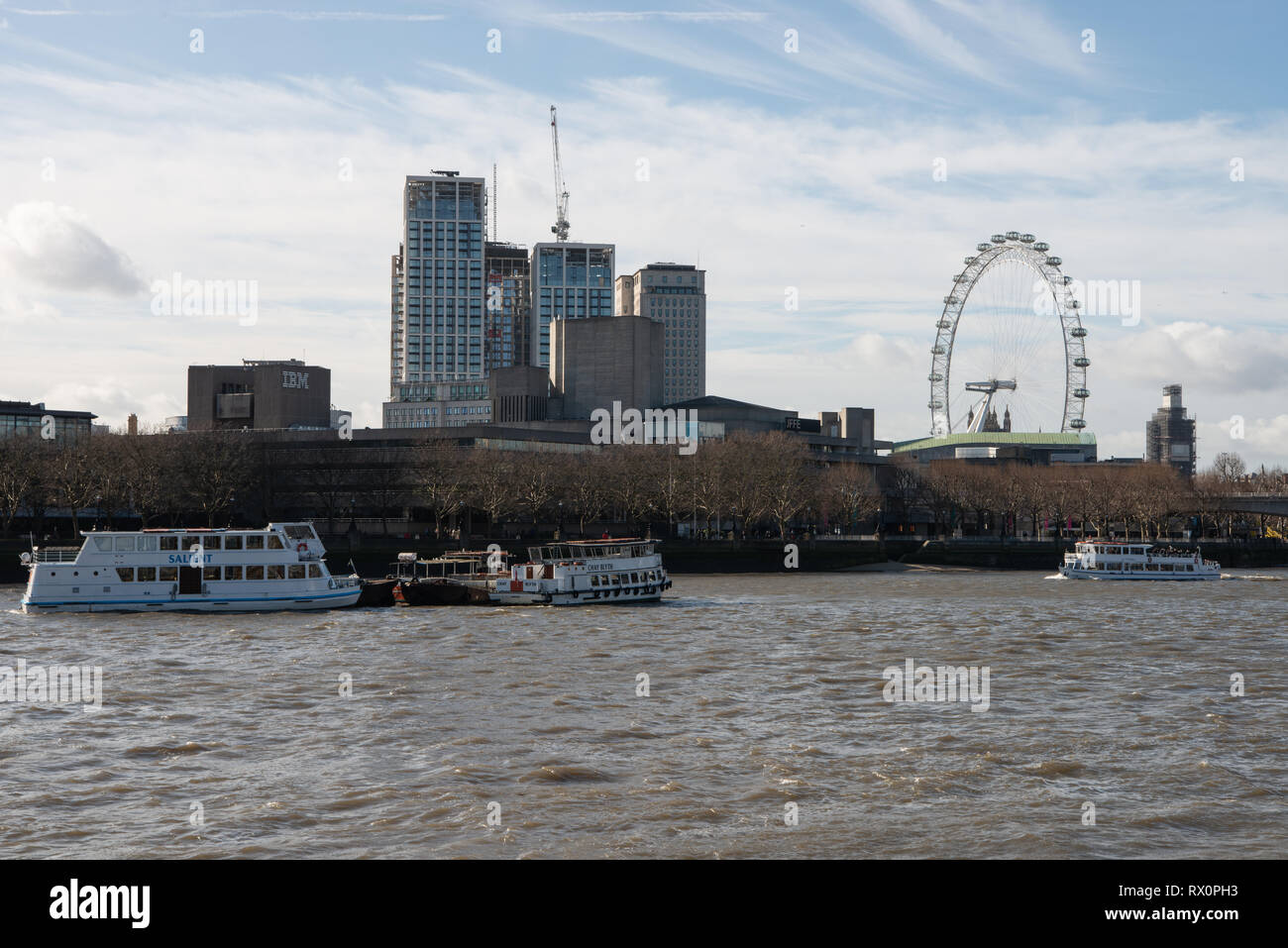 London Embankment In the sunshine on the River Thames With buildings in ...