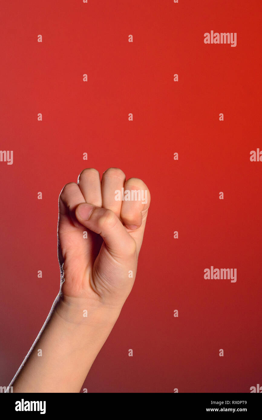 Human hand that squeezed fingers into a fist, symbolizing hatred and ...