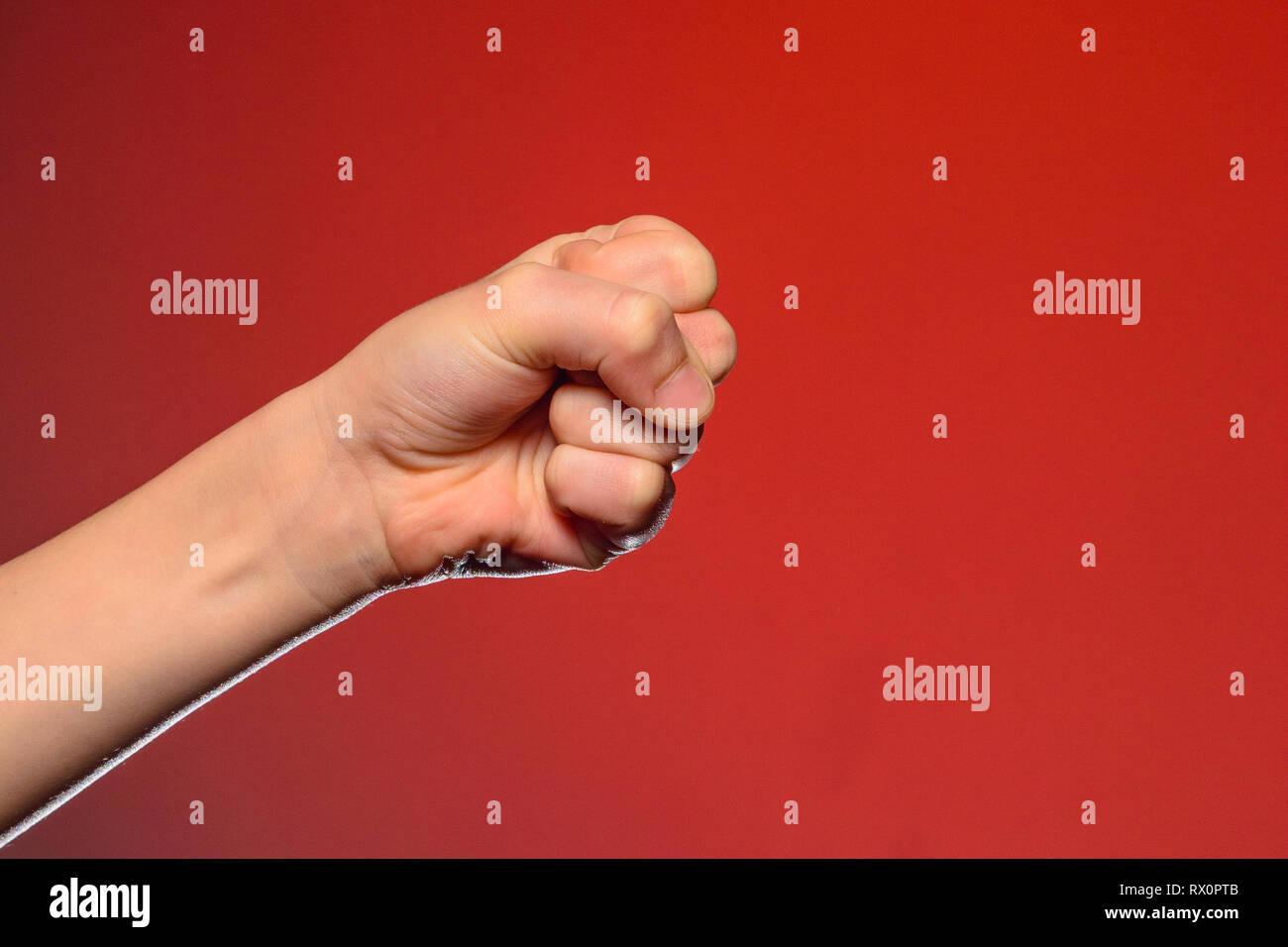 Human hand that squeezed fingers into a fist, symbolizing hatred and ...