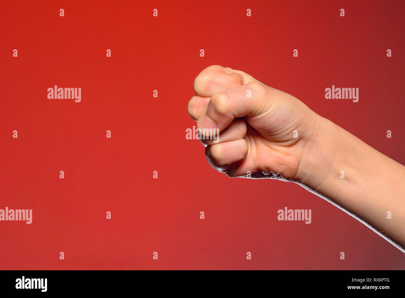 Human hand that squeezed fingers into a fist, symbolizing hatred and ...