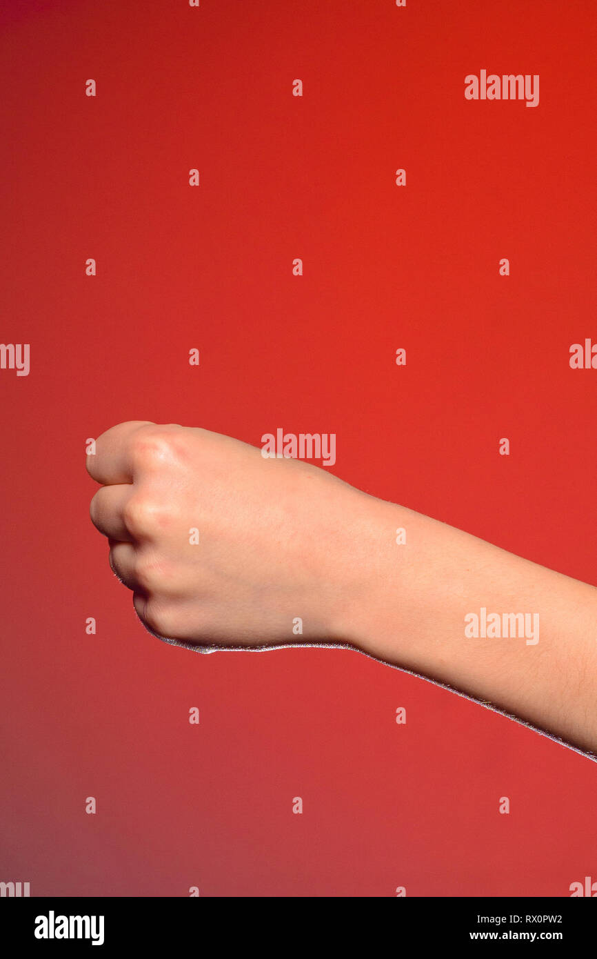 Human hand that squeezed fingers into a fist, symbolizing hatred and ...