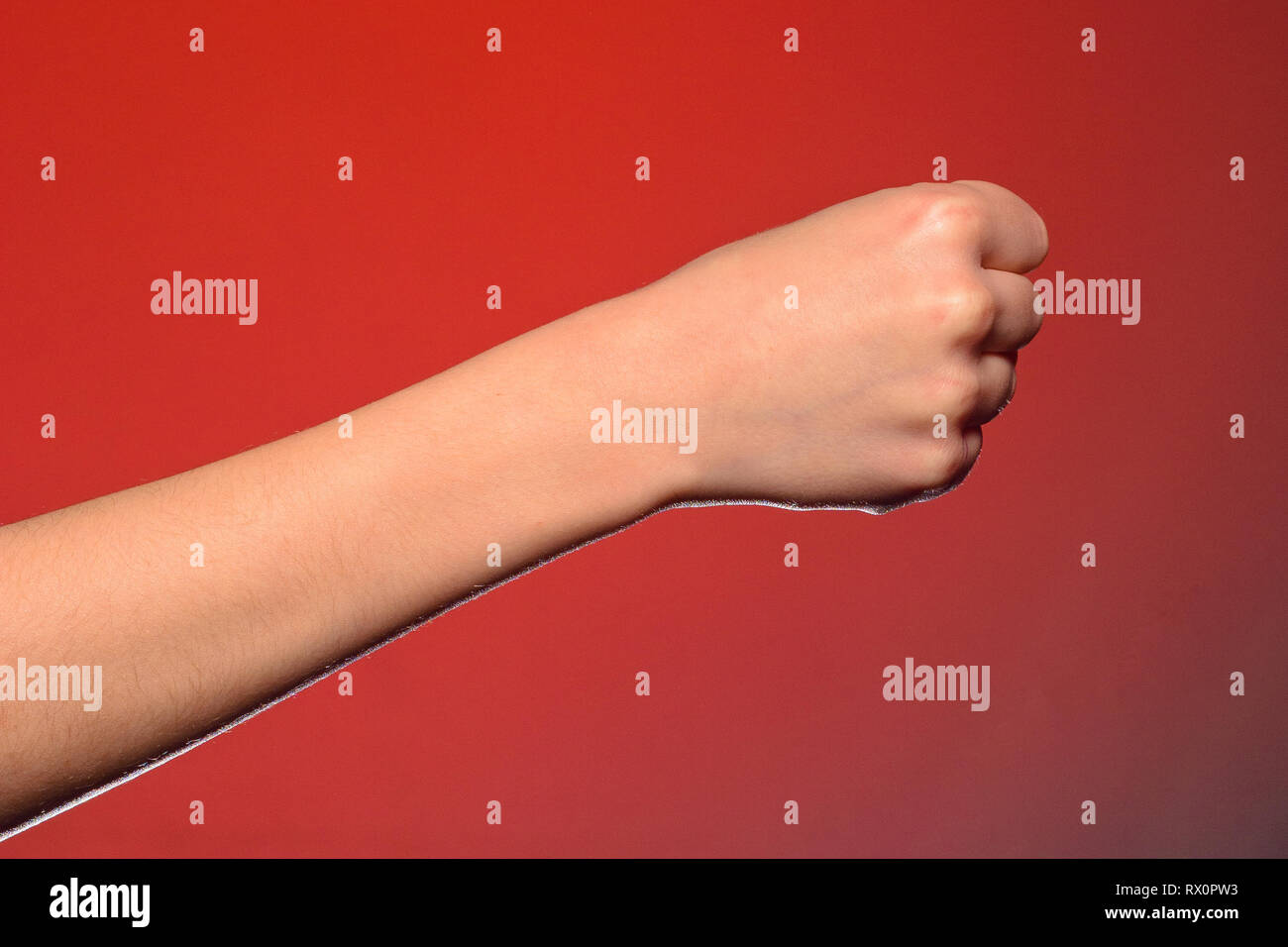 Human hand that squeezed fingers into a fist, symbolizing hatred and ...