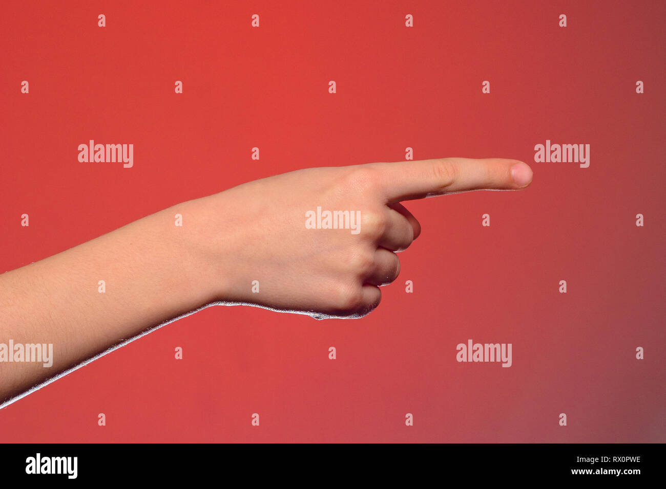 Human hand, showing an index finger on an object isolated on a red ...