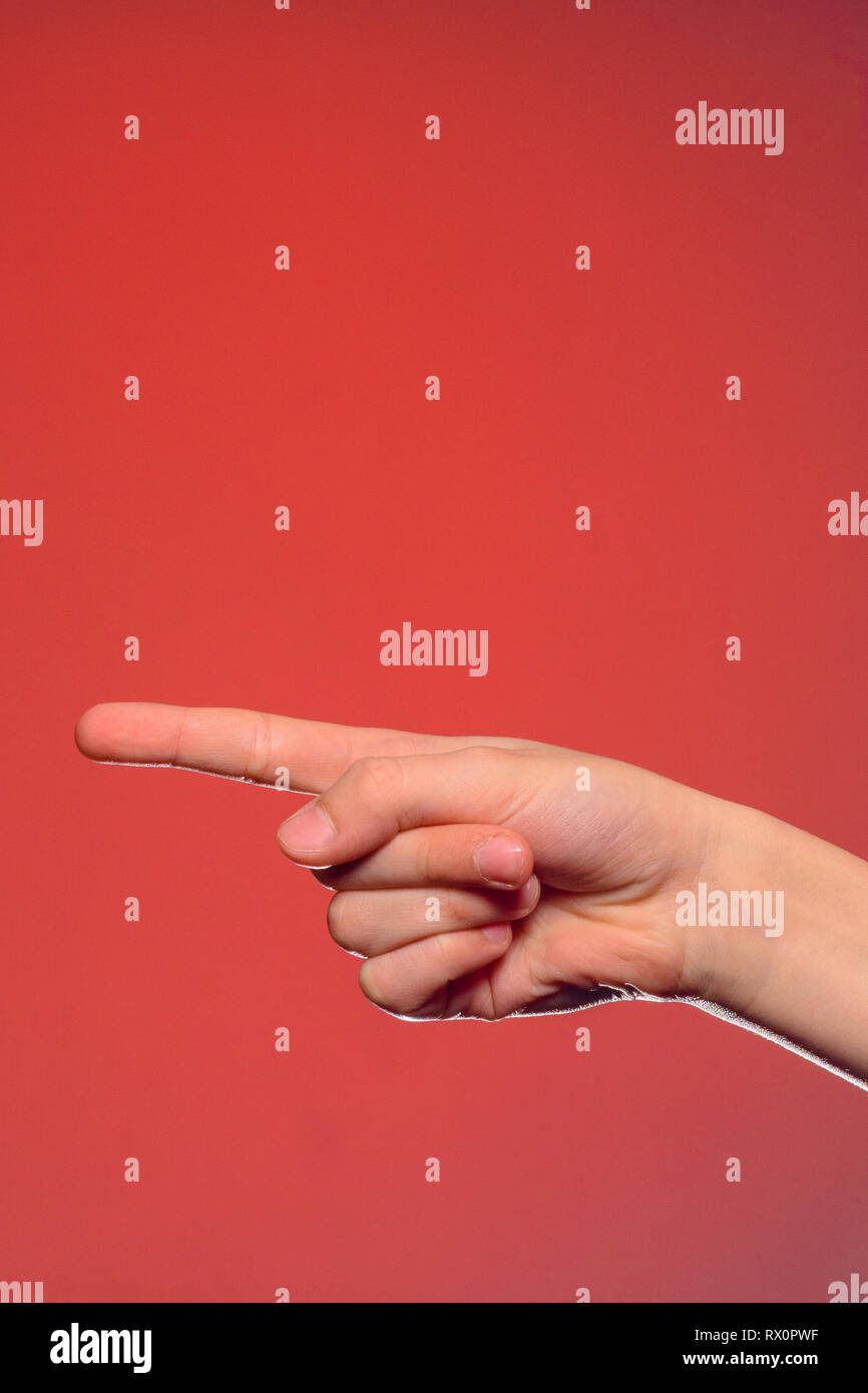 Human hand, showing an index finger on an object isolated on a red ...