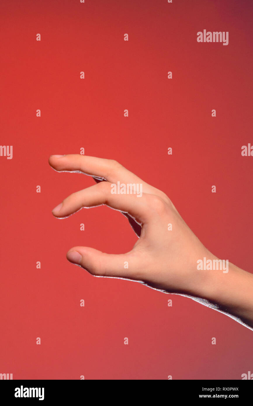 Human hand, folded together to take a little small, isolated on a red ...