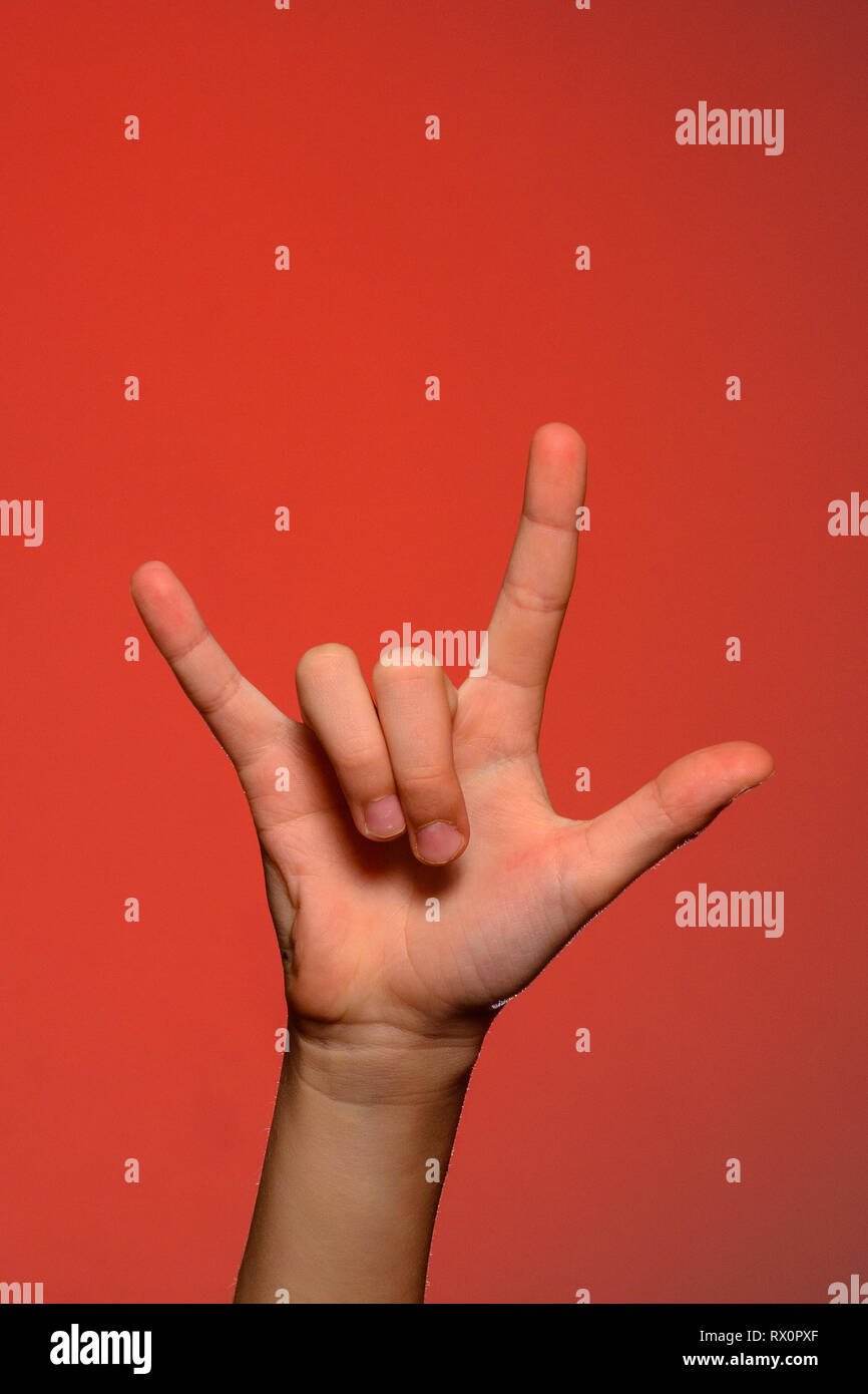 Human hand showing three fingers, symbolizing rock style, isolated on a ...