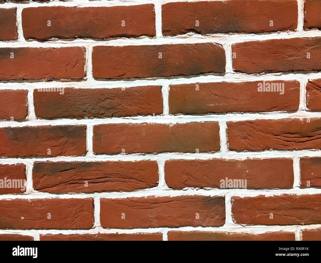 Red brick red rough wall texture background Stock Photo - Alamy