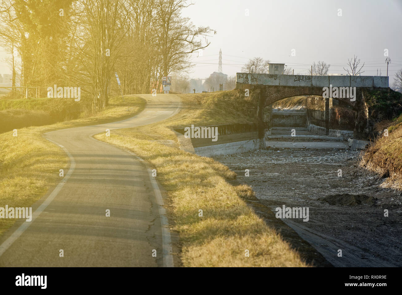 Empty running road near dry water canal Stock Photo - Alamy