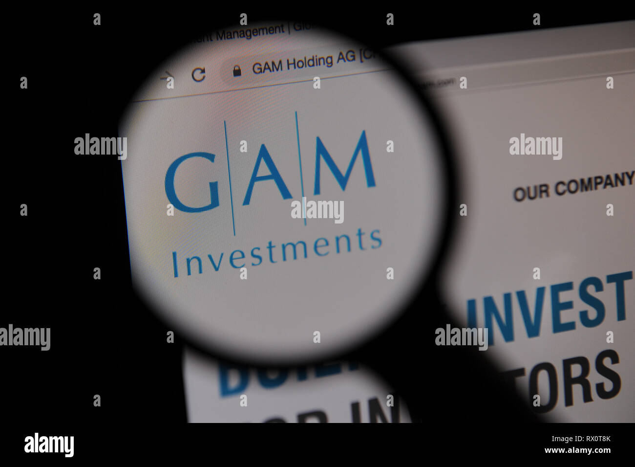 GAM Investments website seen through a magnifying glass Stock Photo - Alamy