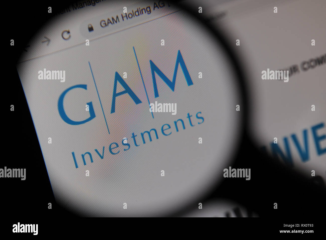 GAM Investments website seen through a magnifying glass Stock Photo - Alamy