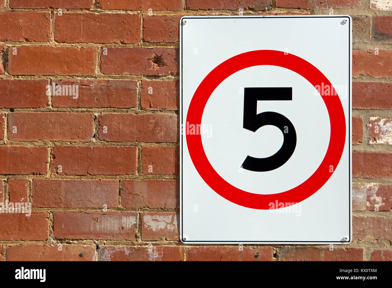 Australian speed sign 5 in red with brick wall background. In Australia ...