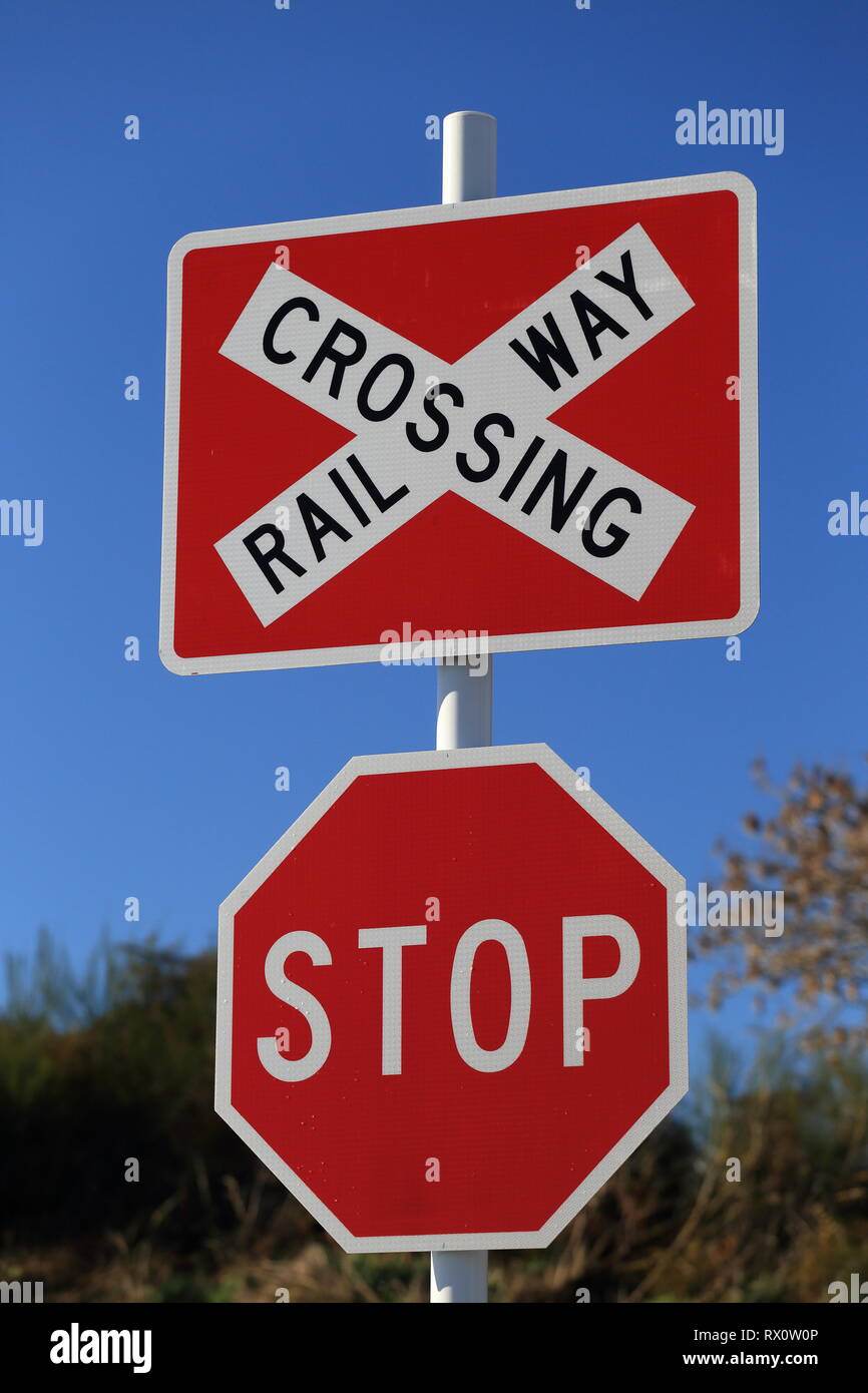 Stop sign at railway crossing Stock Photo - Alamy