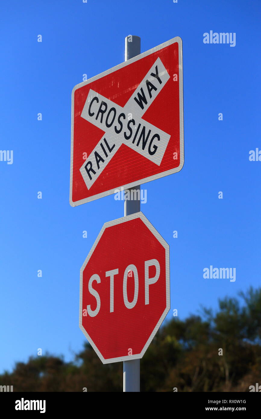 Stop sign at railway crossing Stock Photo - Alamy
