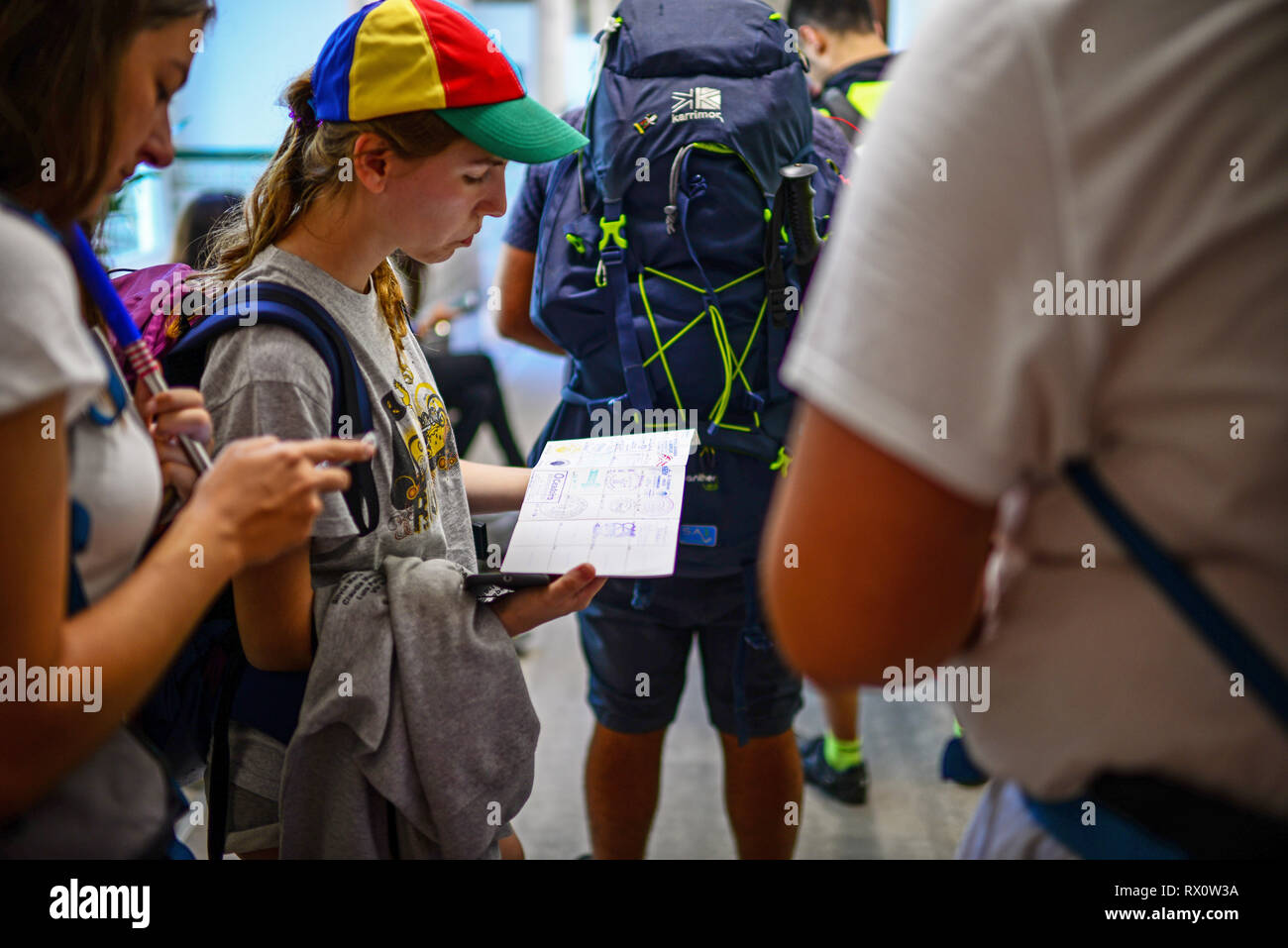 Pilgrims wait for the Official Camino Passport (Credential) after ...