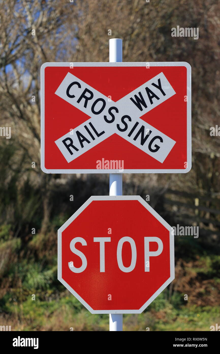 Stop sign at railway crossing Stock Photo - Alamy