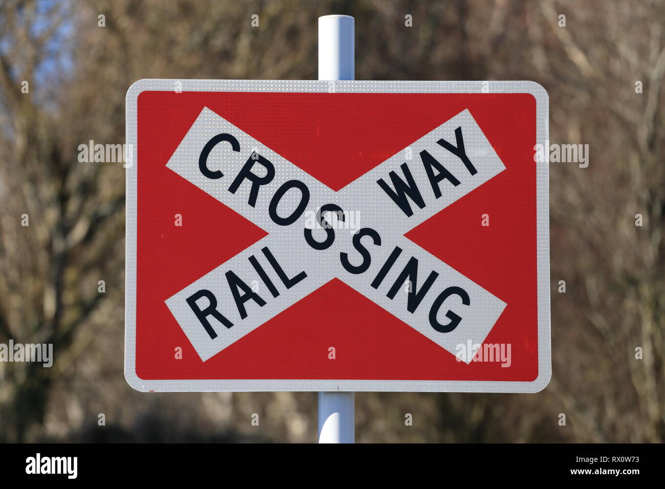 Stop sign at railway crossing Stock Photo - Alamy