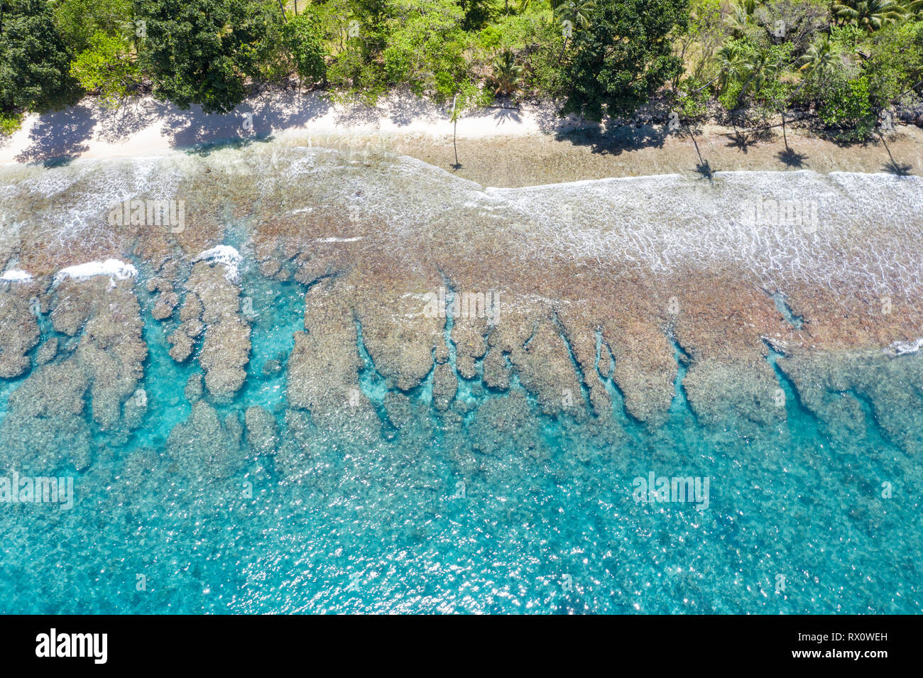 Aerial view of reef and island in Papua New Guinea. The remote ...