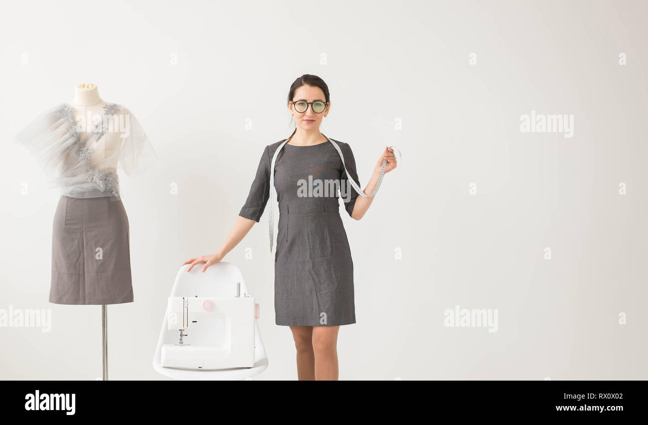 Dressmaker, fashion designer and tailor concept - Young dressmaker ...