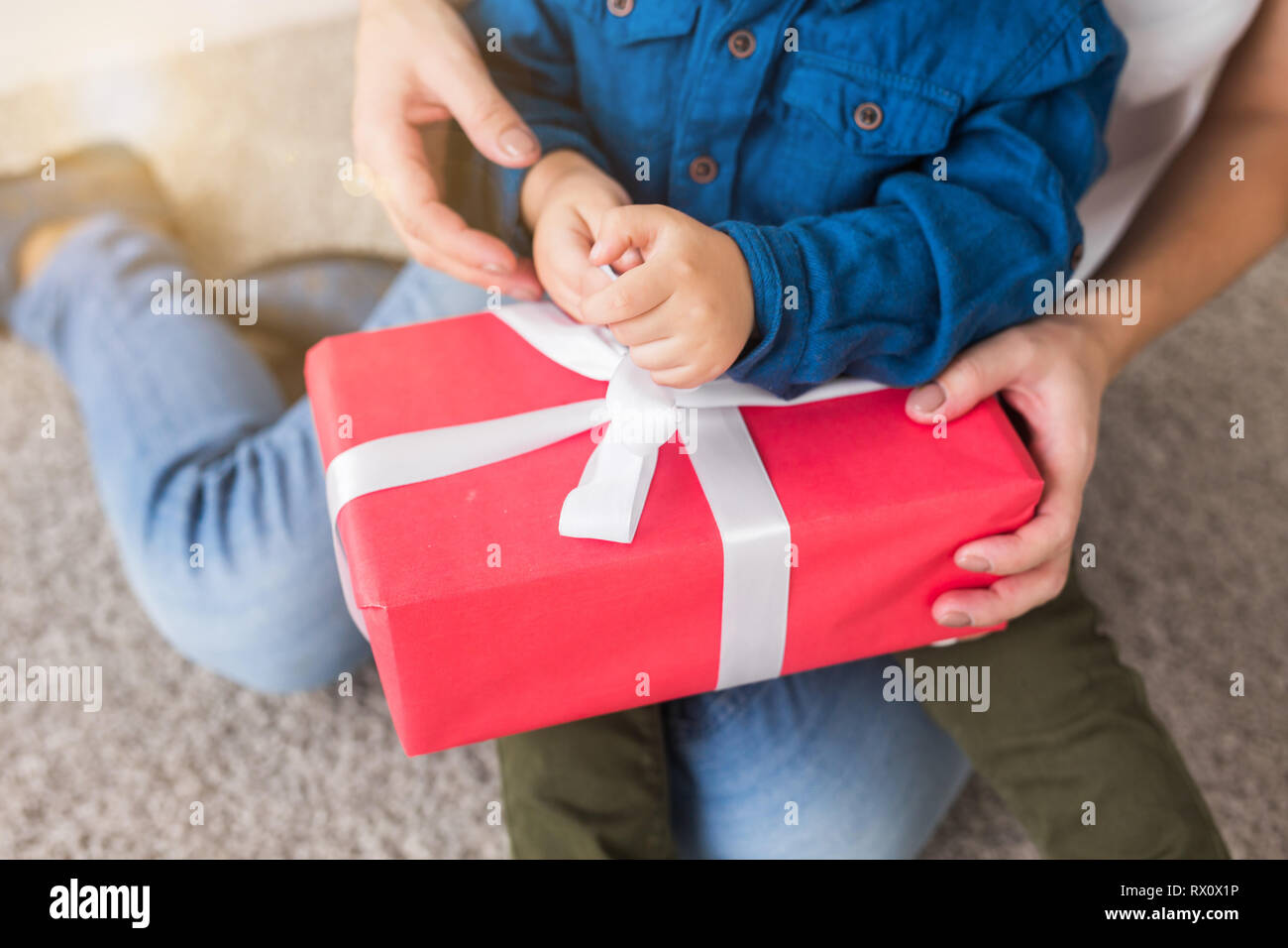 Children, birthday and holiday concept - Little child boy opening red ...