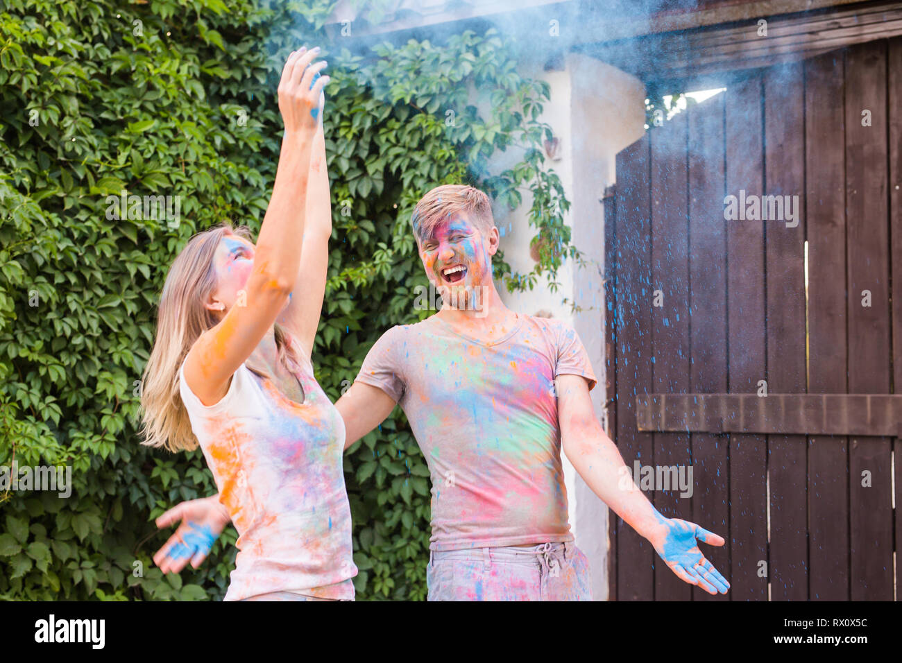Festival of holi, friendship - young people playing with colors at the ...