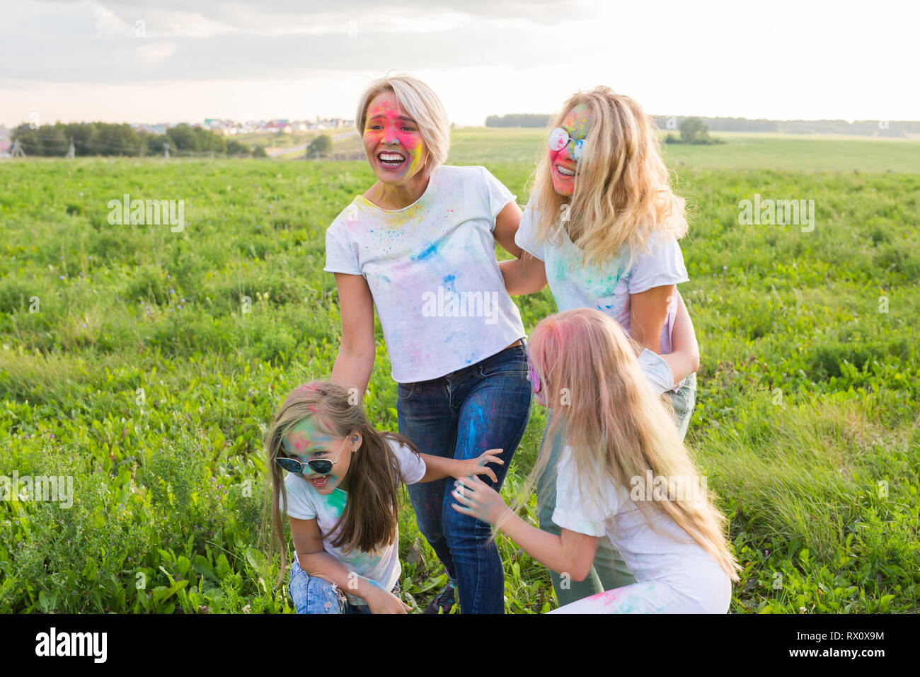 Holiday, summer and fun concept - Group of people dancing in field at ...