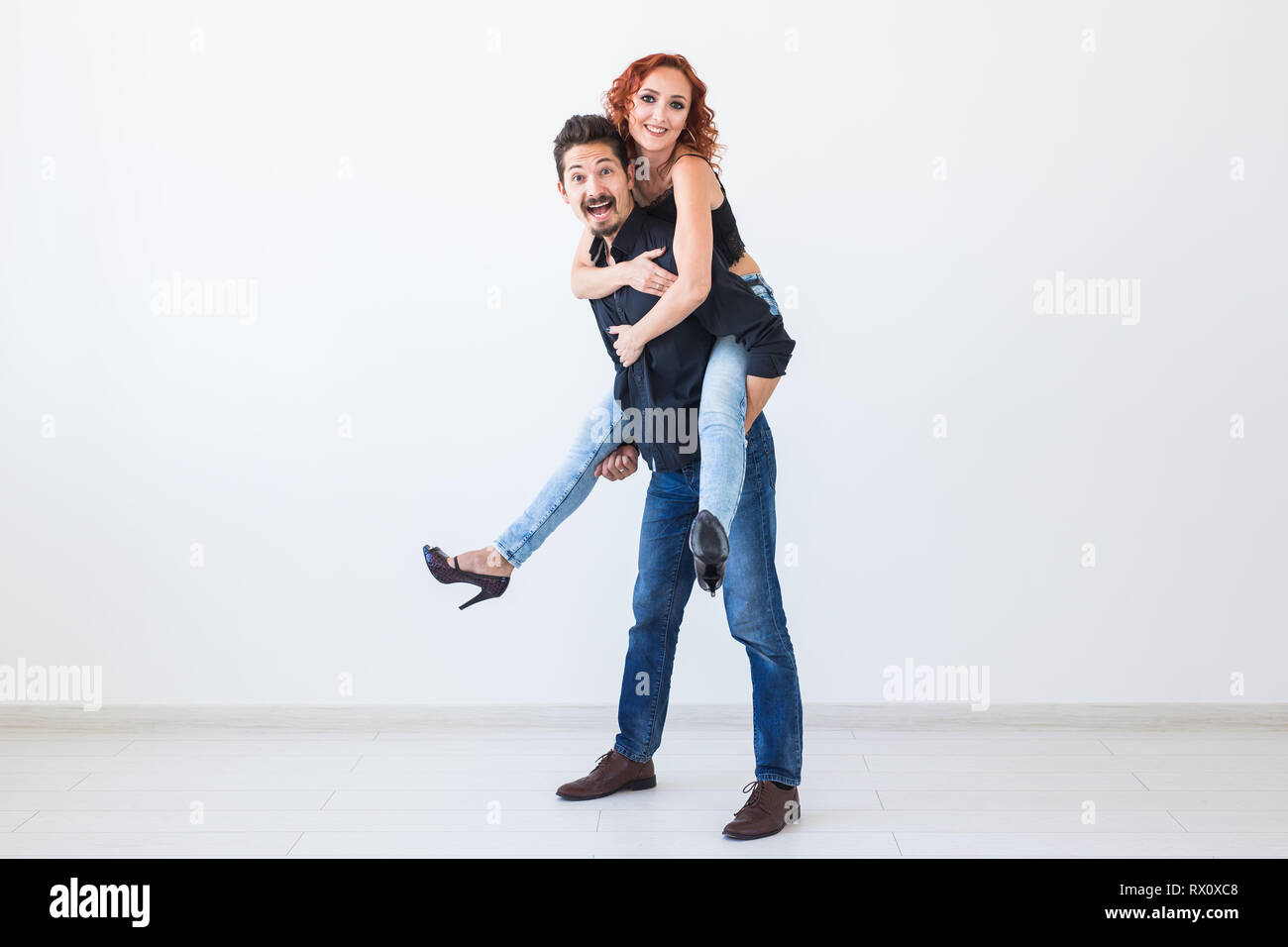 Friendship, people concept - young woman jumped on the man's back Stock ...