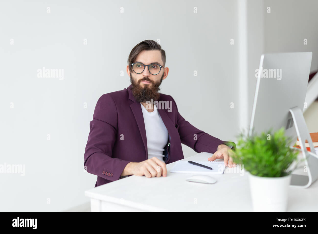 People and technology concept - Man sits and works at the computer ...
