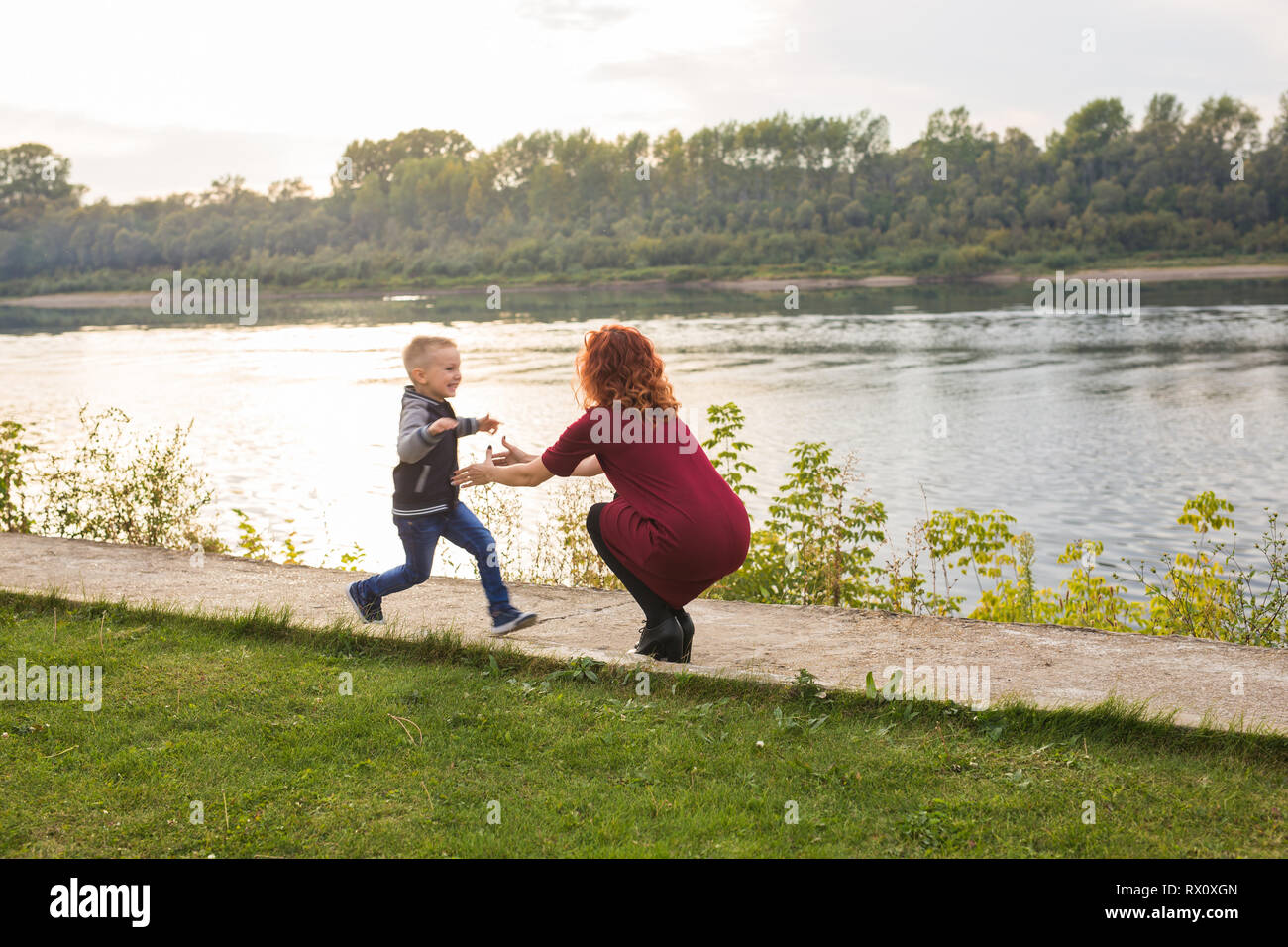 Motherhood and children concept - Son runs into his mother's arms Stock ...