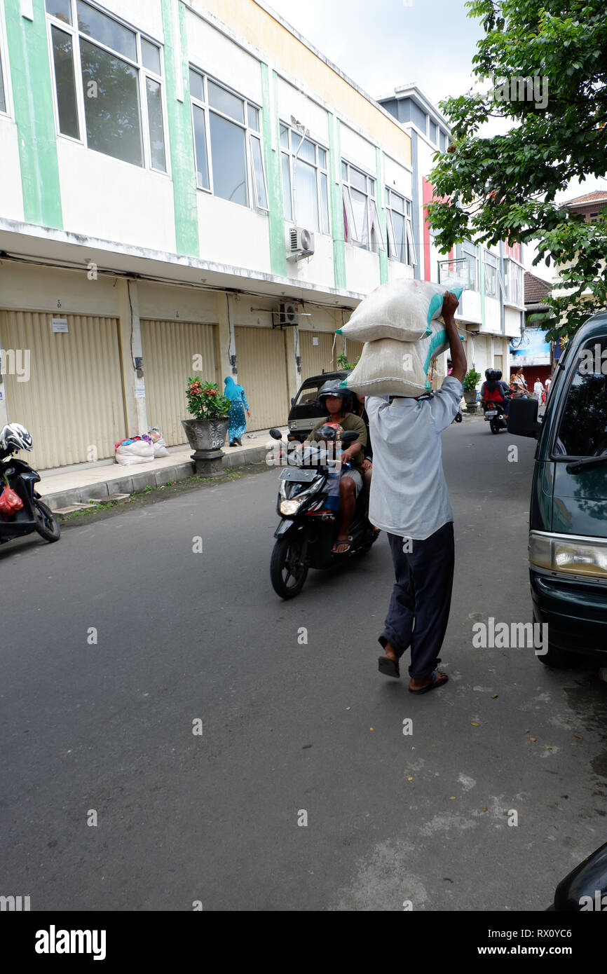 people carrying items in plastic bags Stock Photo - Alamy