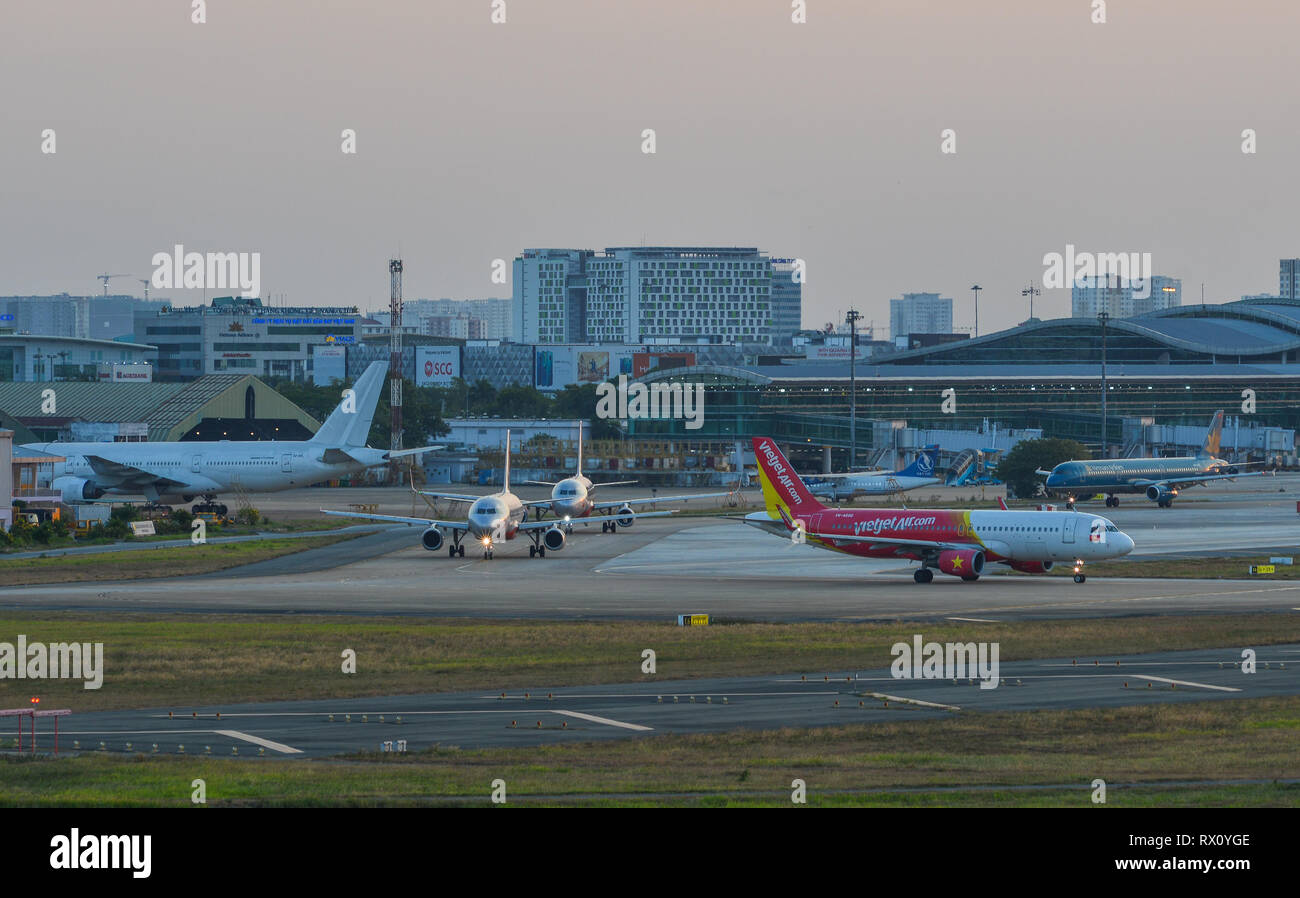Saigon, Vietnam - Mar 2, 2019. Passenger airplanes taxiing on runway of ...