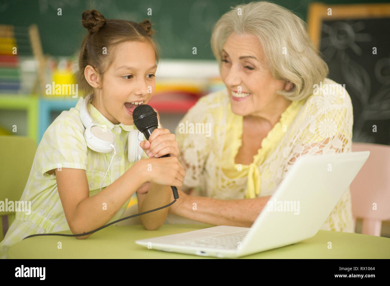Portrait of grandmother and daughter singing karaoke Stock Photo - Alamy