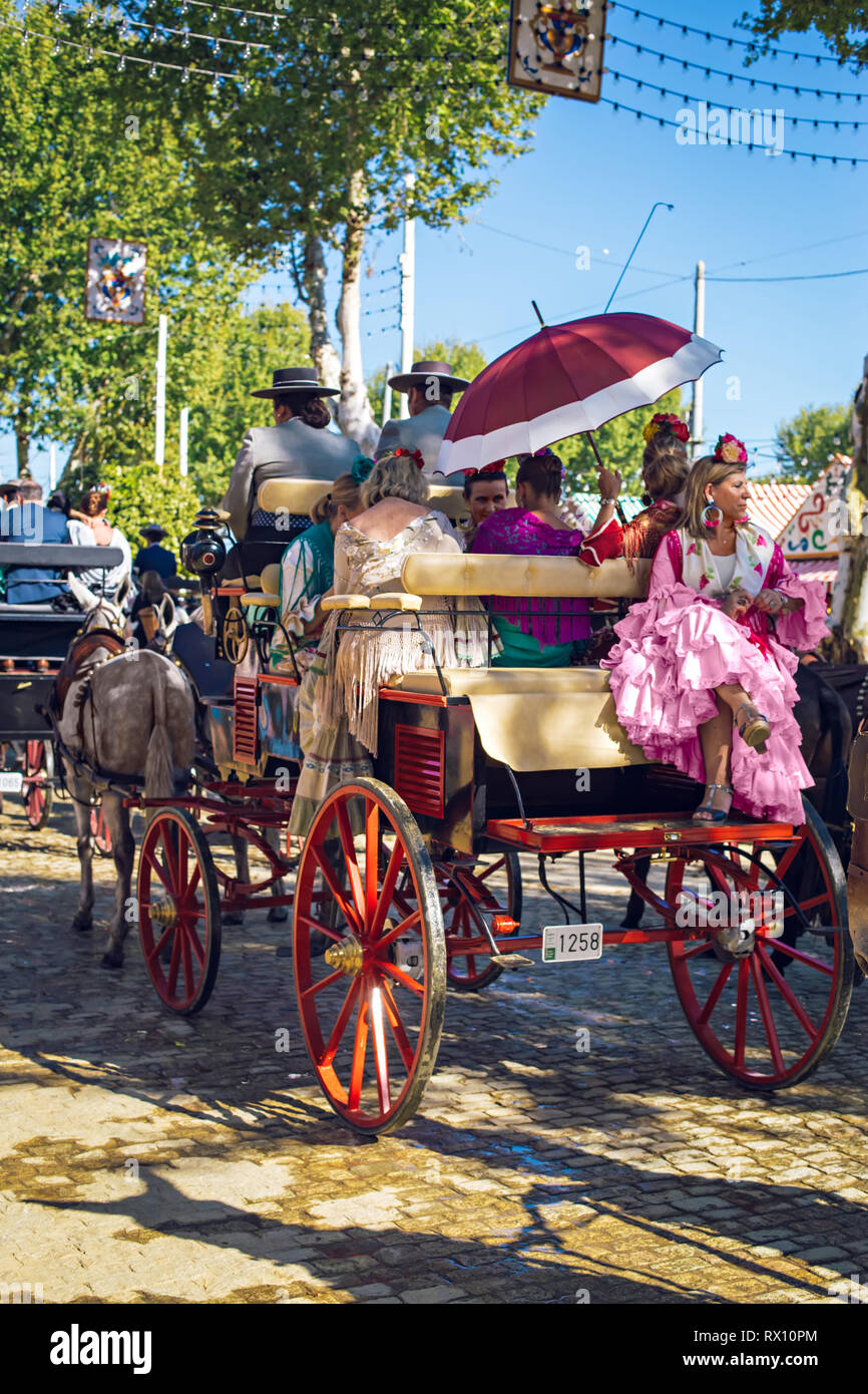 Beautiful woman in traditional and colorful dress travelling in a horse ...