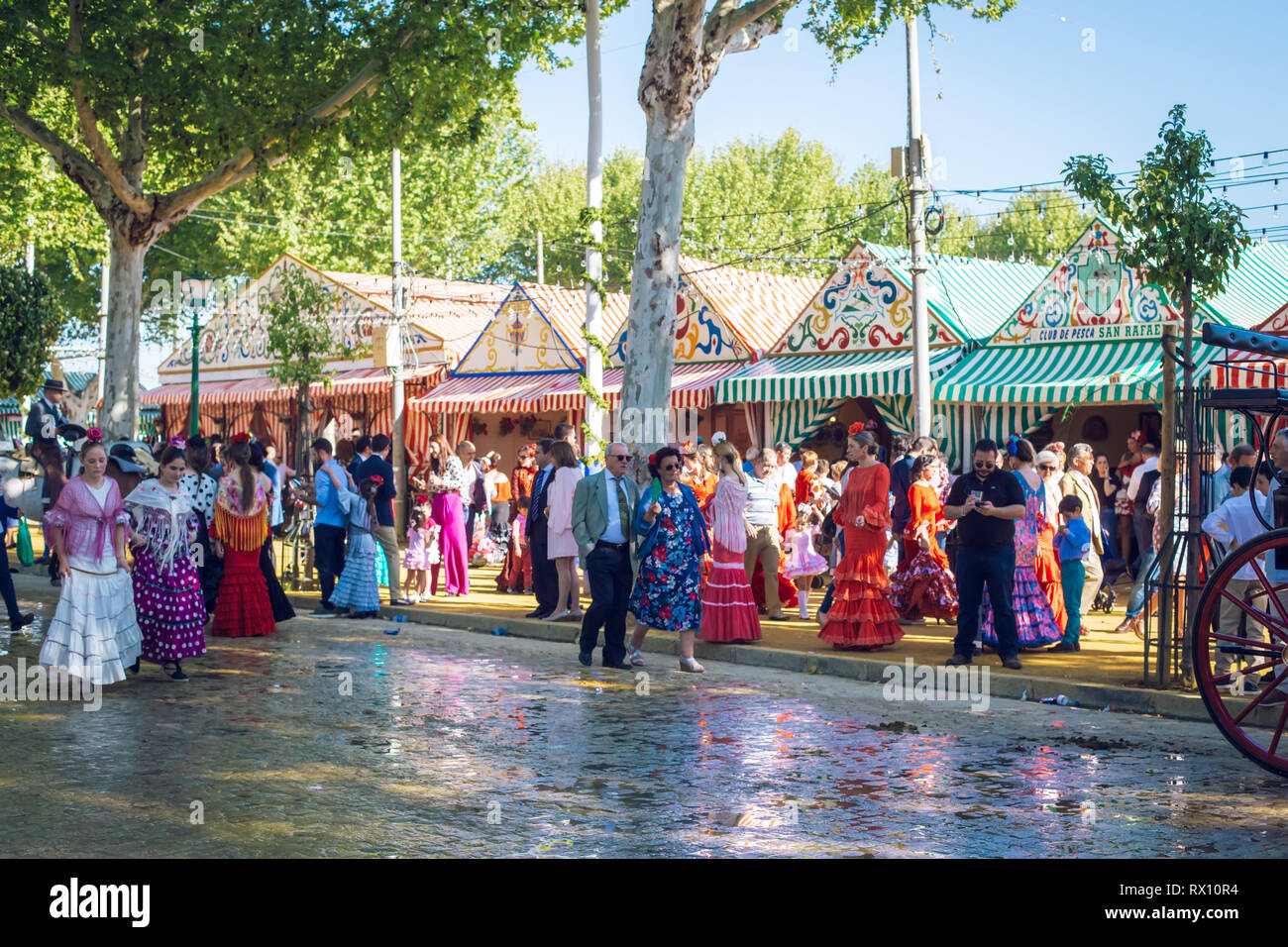 People dressed in traditional costumes enjoy April Fair. Seville Fair ...