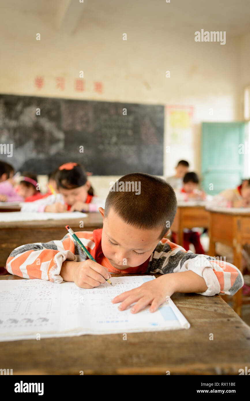 Elementary age school children attending class in a rural classroom in ...
