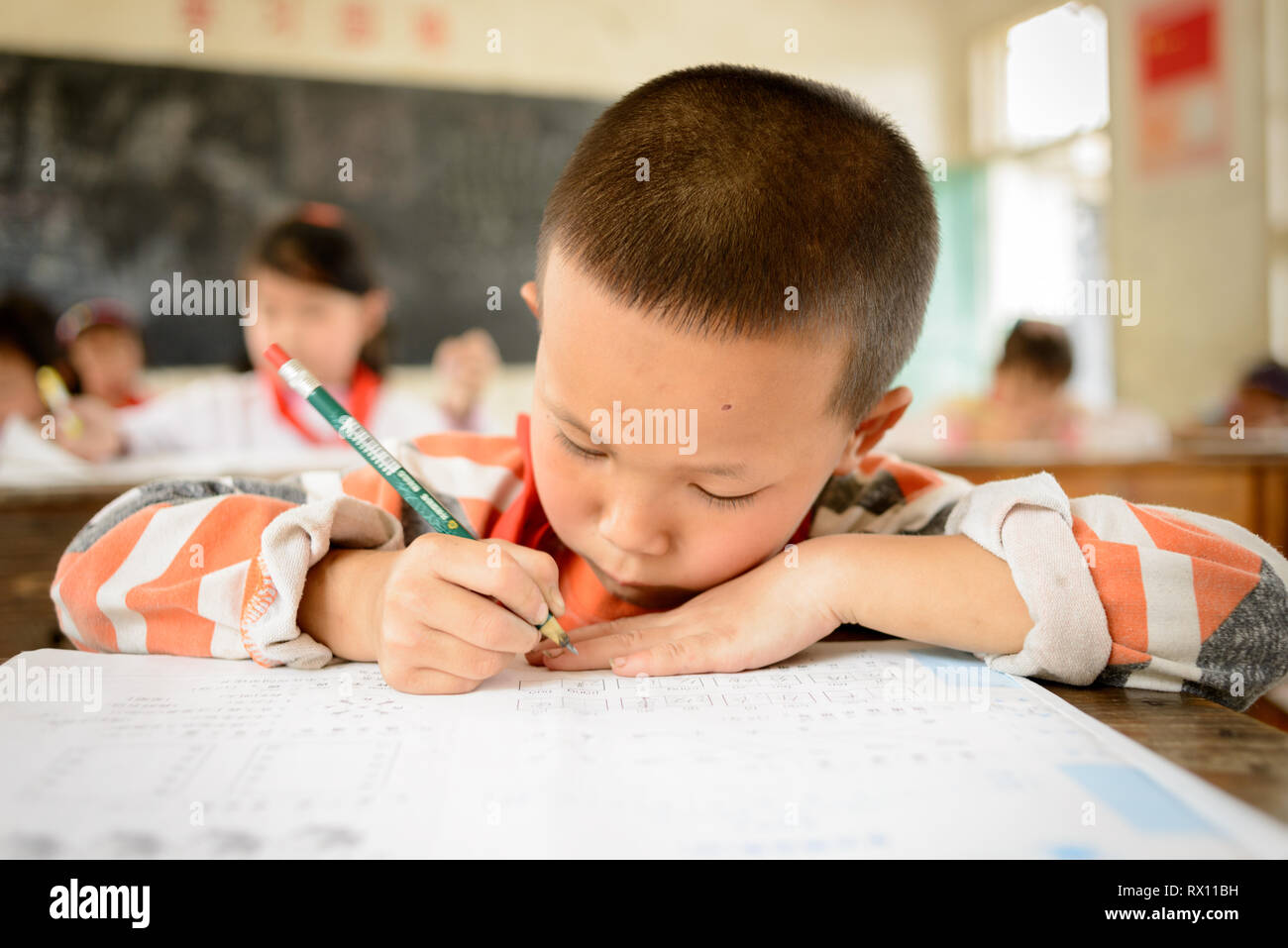 Elementary age school children attending class in a rural classroom in ...