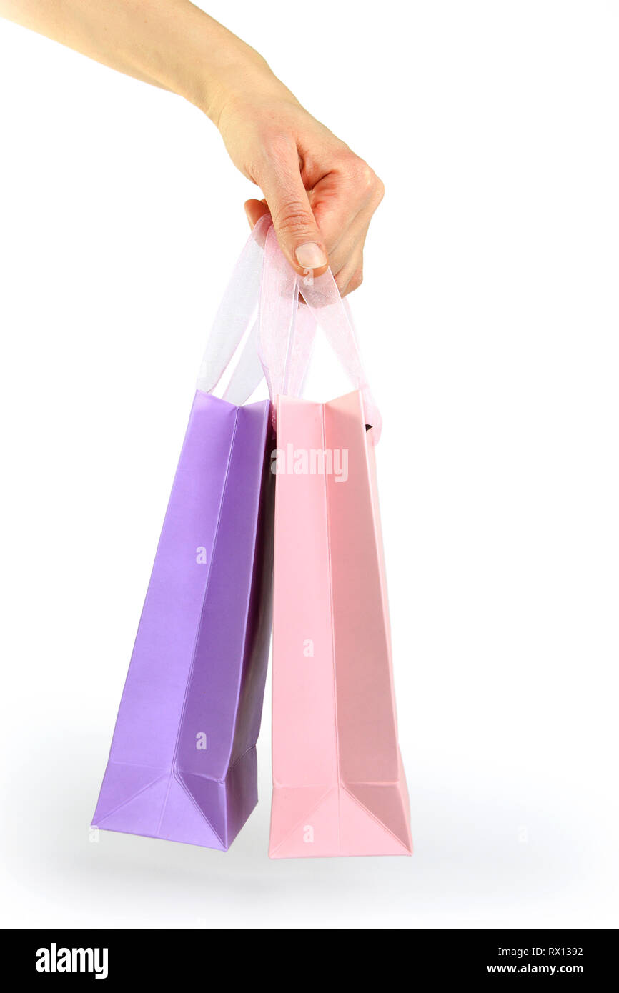 Hand holding colorful shopping bags isolated on white Stock Photo - Alamy