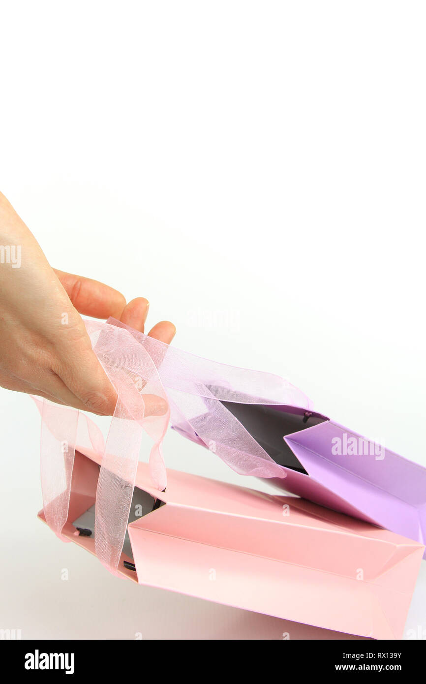 Hand holding colorful shopping bags isolated on white Stock Photo - Alamy
