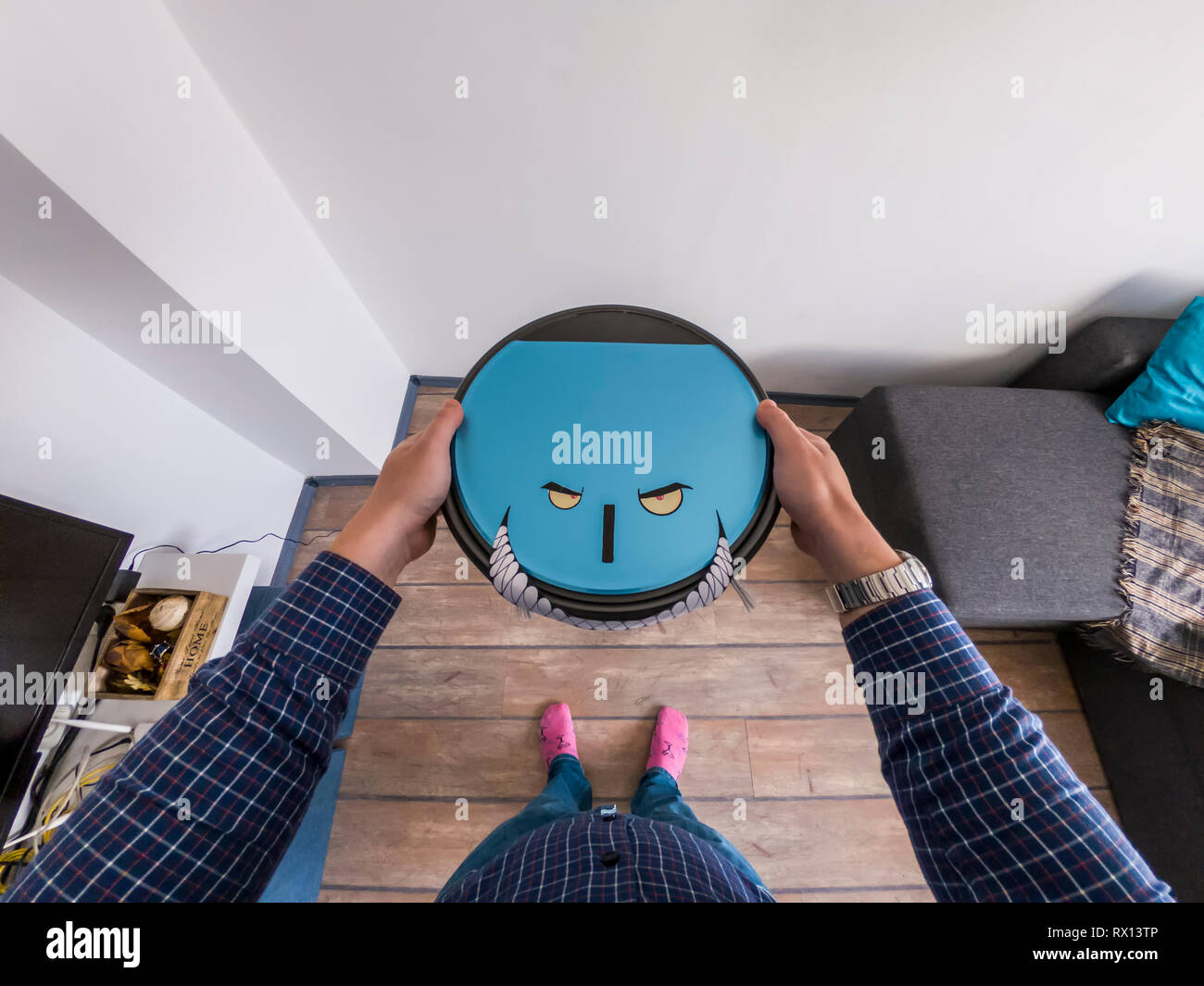 Robots takeover, robots as pets and evil robots concept. Man holding a ...