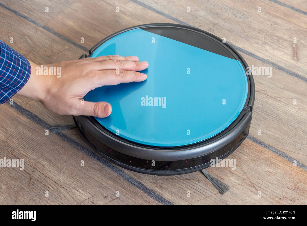 Hand petting a robot vacuum cleaner. Pet behavior concept Stock Photo ...