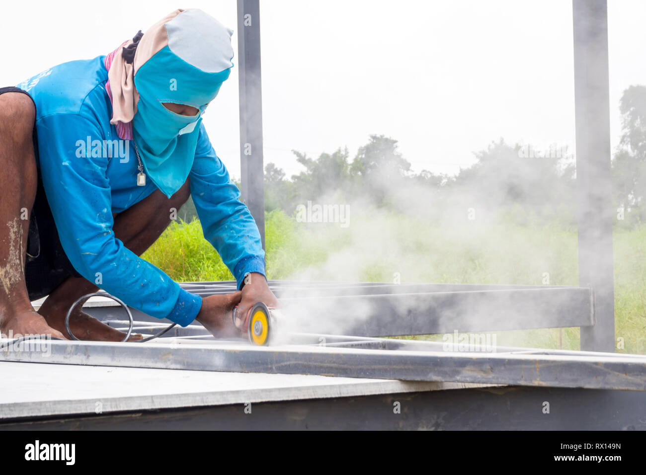 Workers cutting materials with a cutting machine in countryside ...